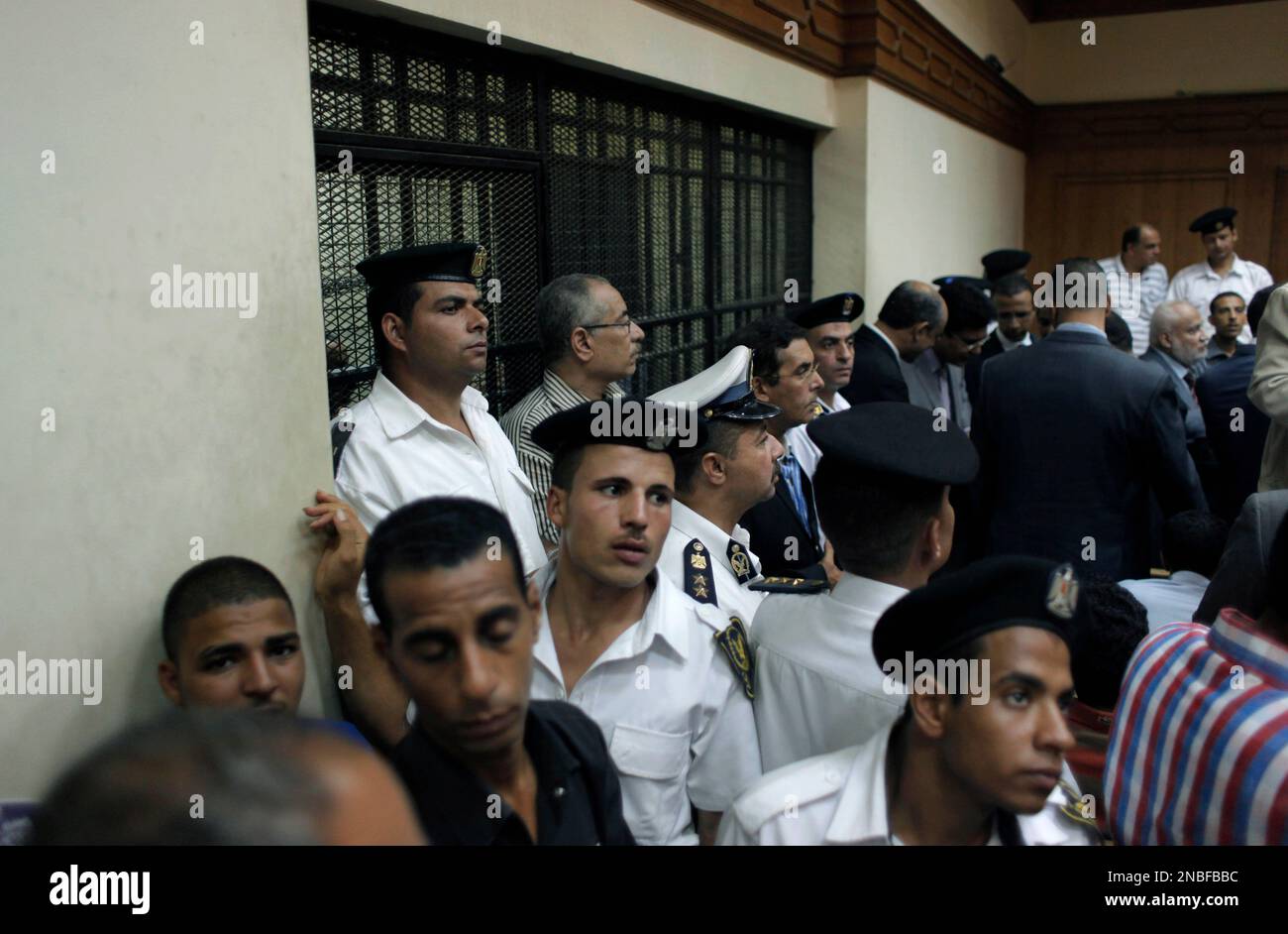 Egyptian security officers secure the court room ahead of the trial ...