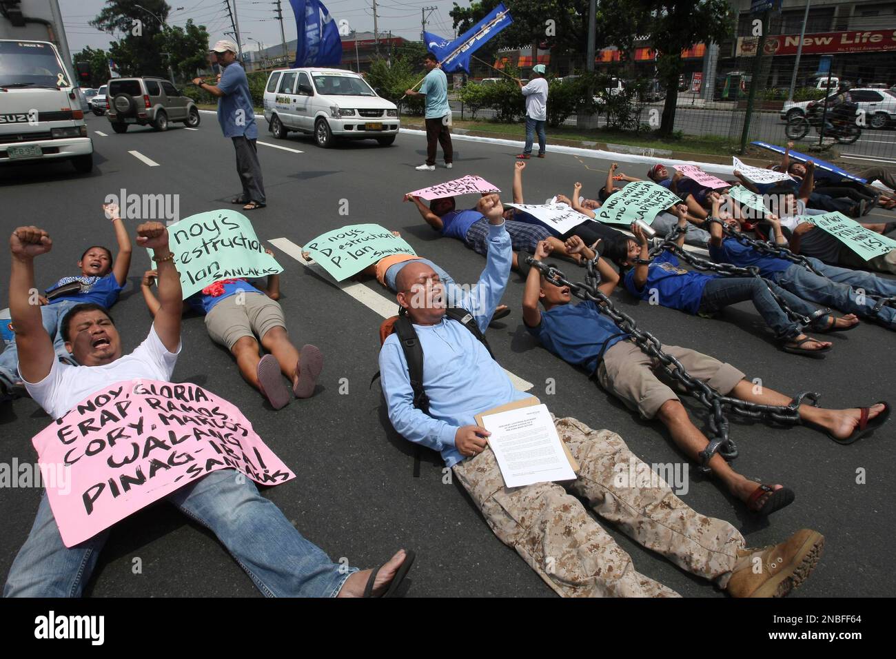 A group of protesters stage a die-in protest to briefly stall the ...