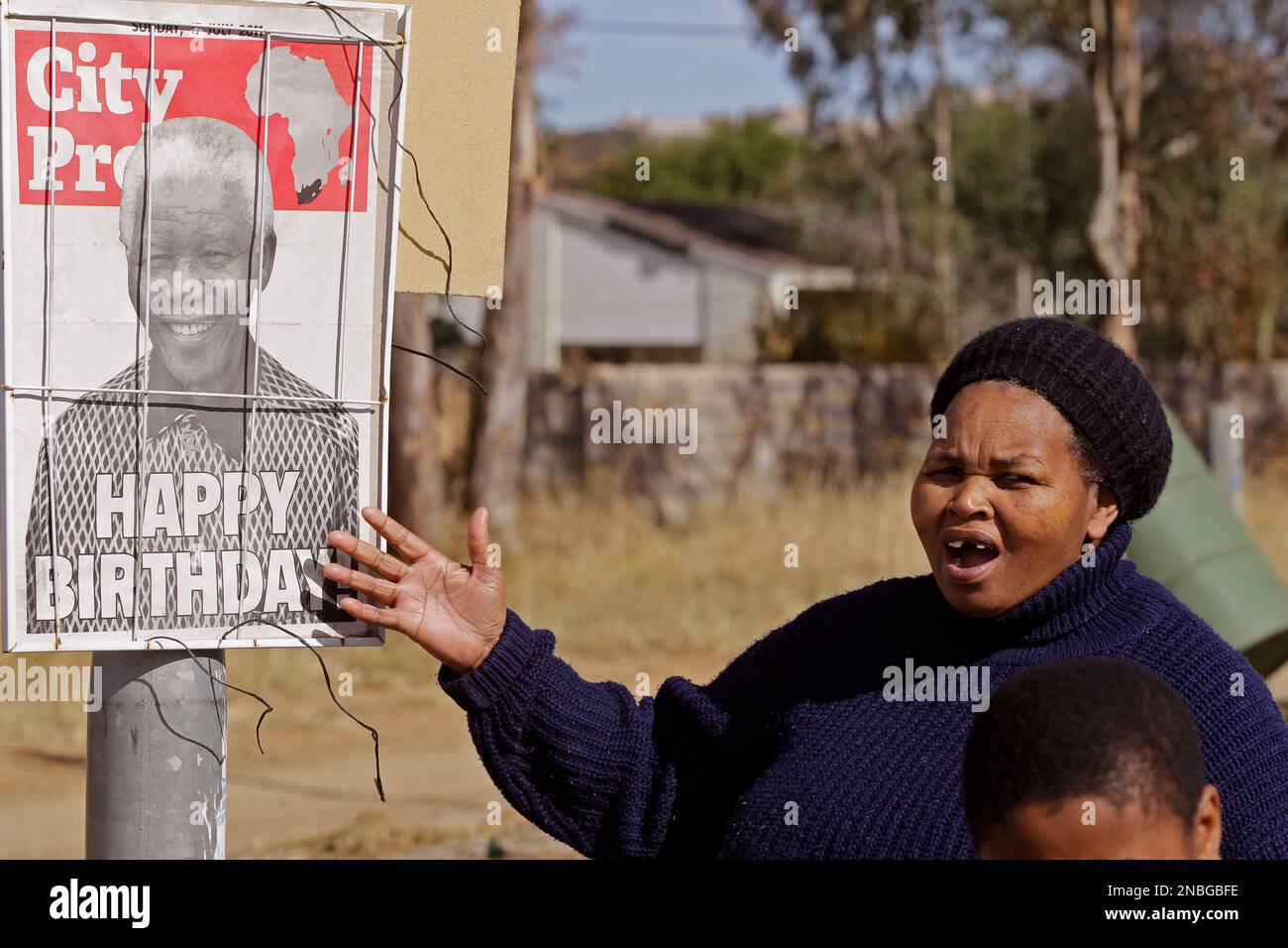 A woman reacts as she see a newspaper poster with a photo of former ...