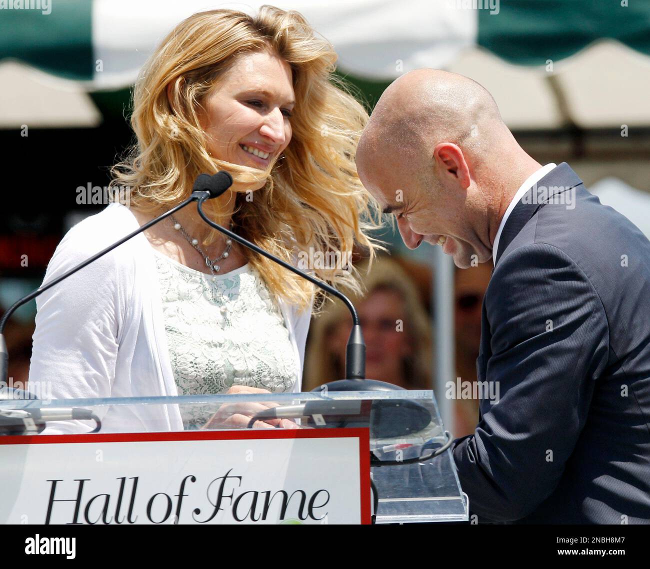 Tennis great Andre Agassi laughs with his wife, Steffi Graf, as he is ...