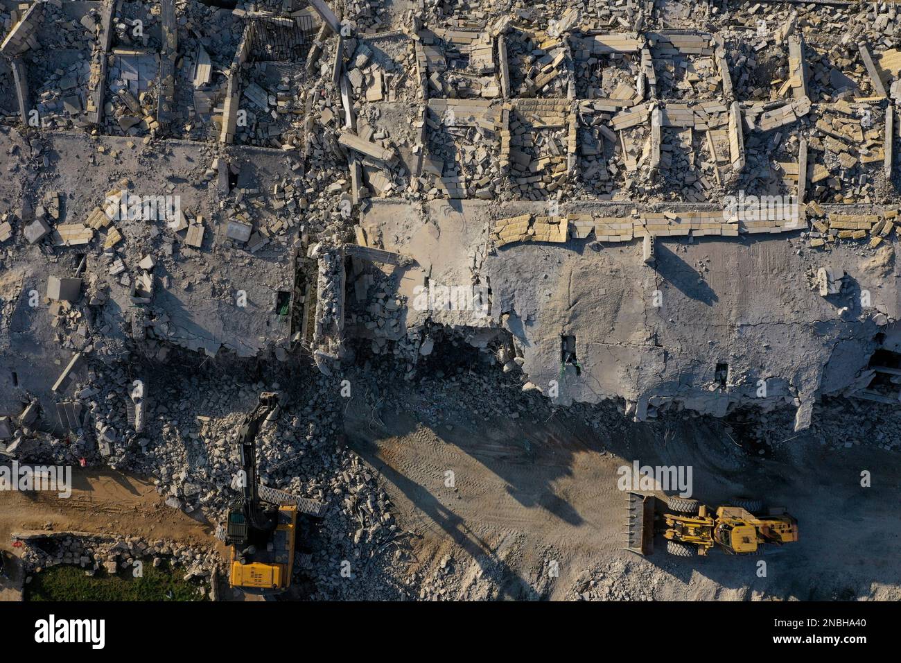 FILE - Rescue workers clear rubble from collapsed houses in Sarmada ...
