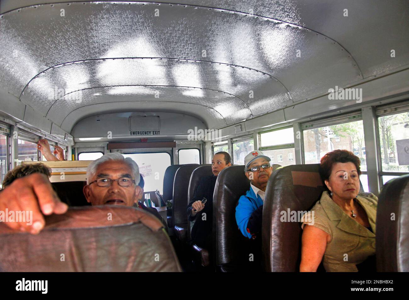 Seniors, including Nora Ramierez, 69, far right, get a school bus ride ...