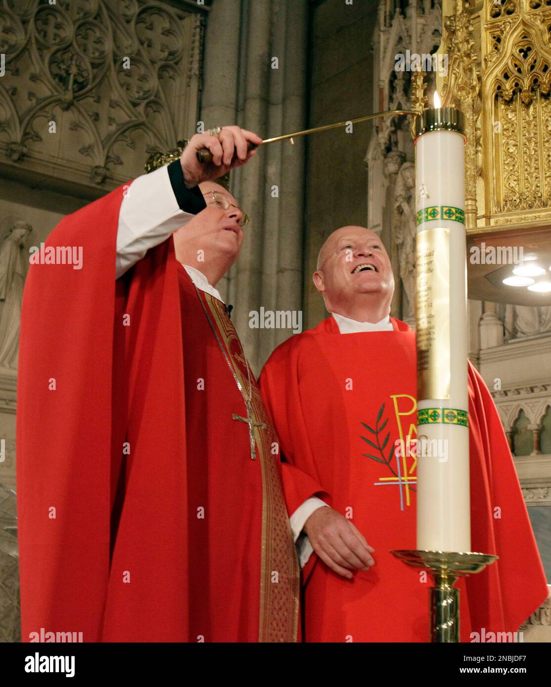 Archbishop Timothy M. Dolan, left, is joined by Msgr. Robert Ritchie ...