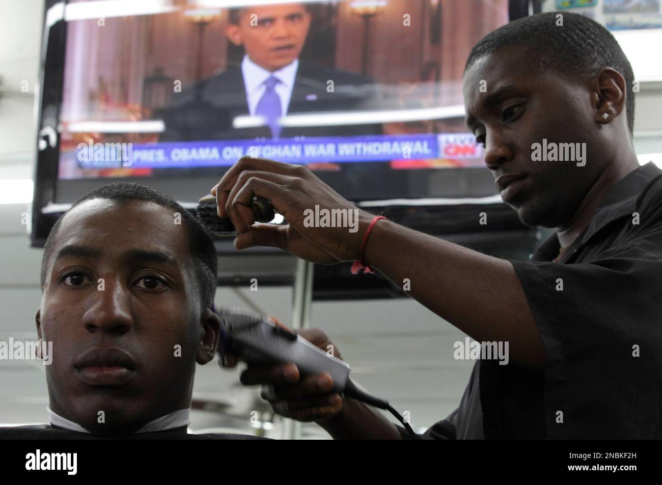 Marine Staff Sargent Brandon Foote, left, gets his hair cut by Darrell ...