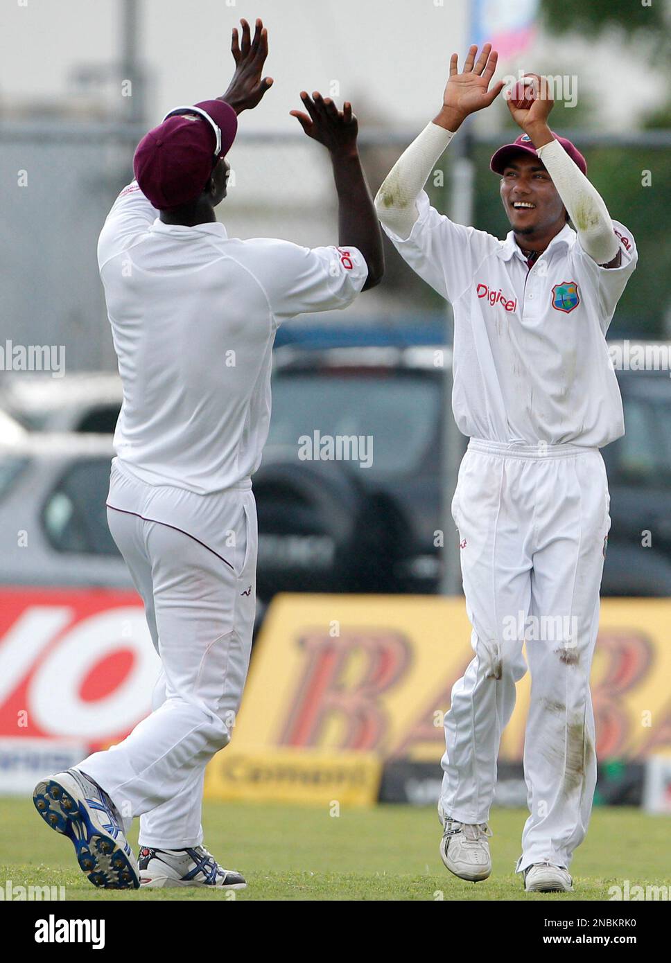 West Indies' Devendra Bishoo, right, high fives his captain Darren ...