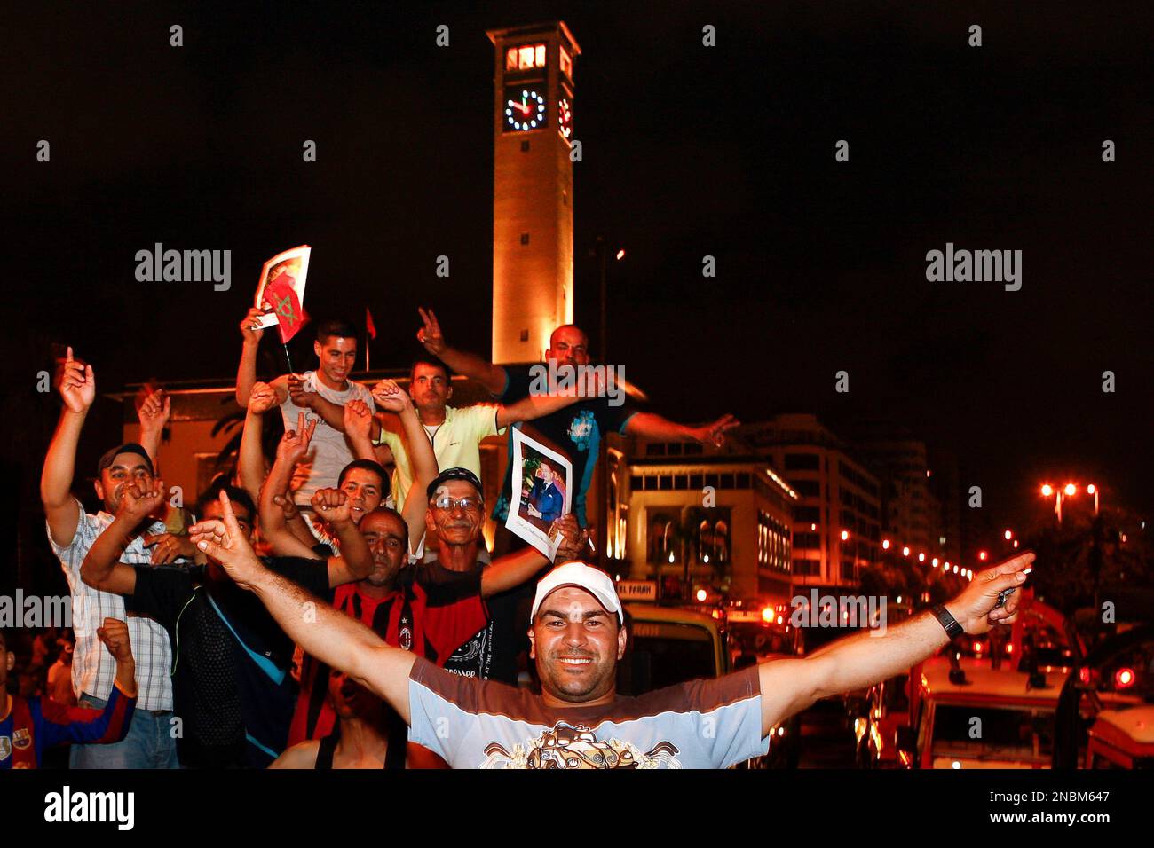 Pro-government supporters hold a picture of Morocco's King Mohammed VI ...
