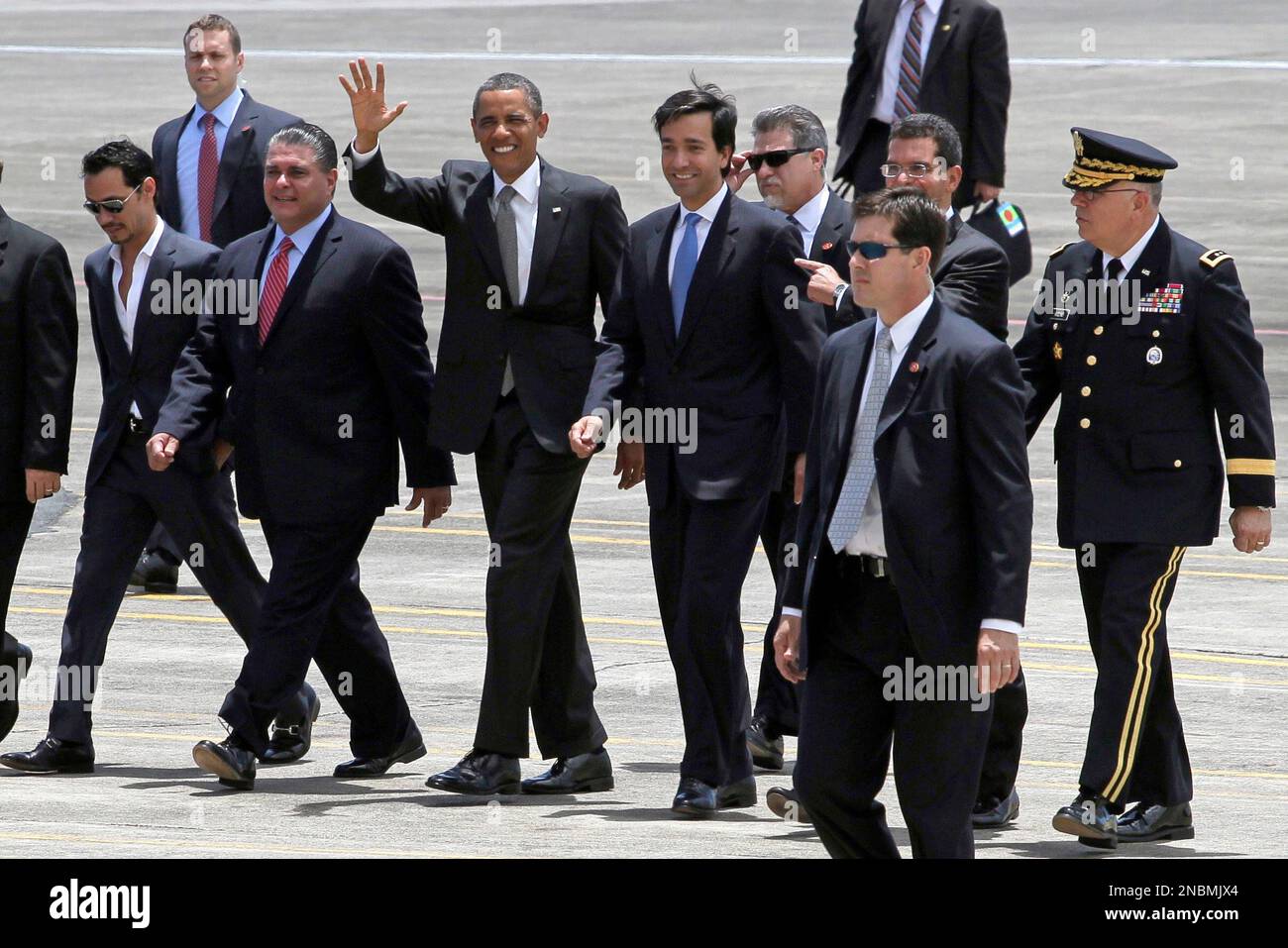 President Barack Obama waves while walking with Puerto Rico's Governor ...