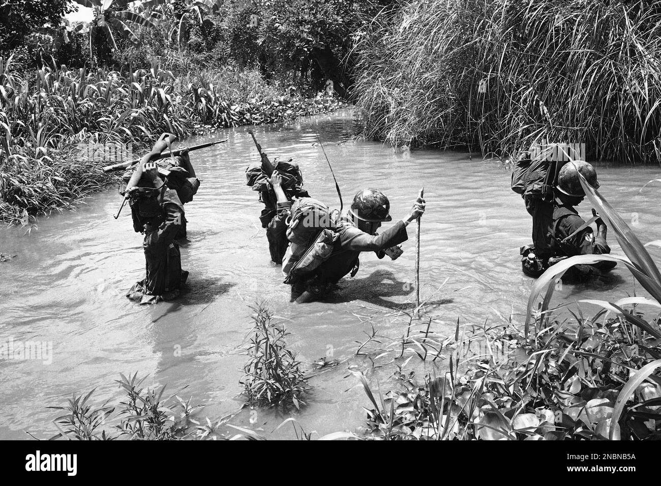 Vietnamese Rangers up to their waists in brown water of a Mekong Delta ...