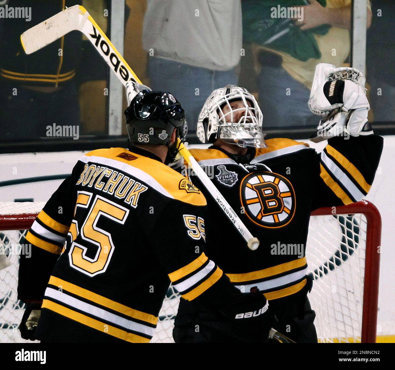 Boston Bruins goalie Tim Thomas, right, reacts with teammate Johnny ...