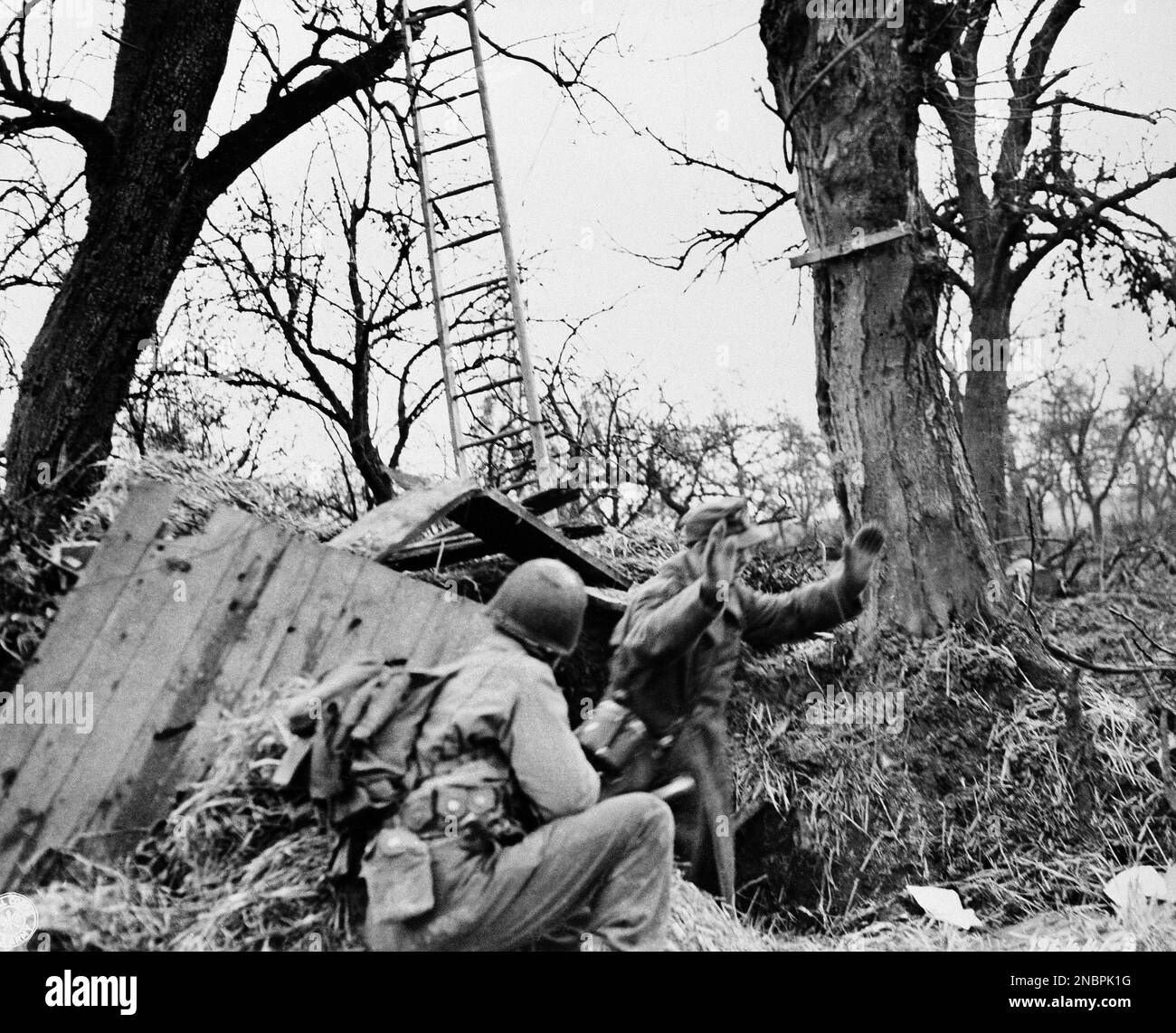 Hands in the air, a German walks out of a dugout to surrender to, ninth ...