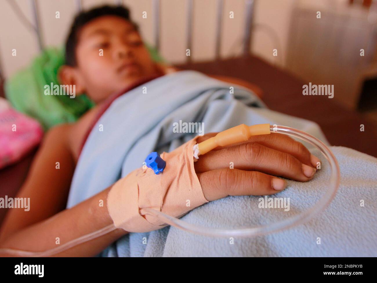 Soung Sokha, 12, who was infected with dengue fever sleeps in a ...
