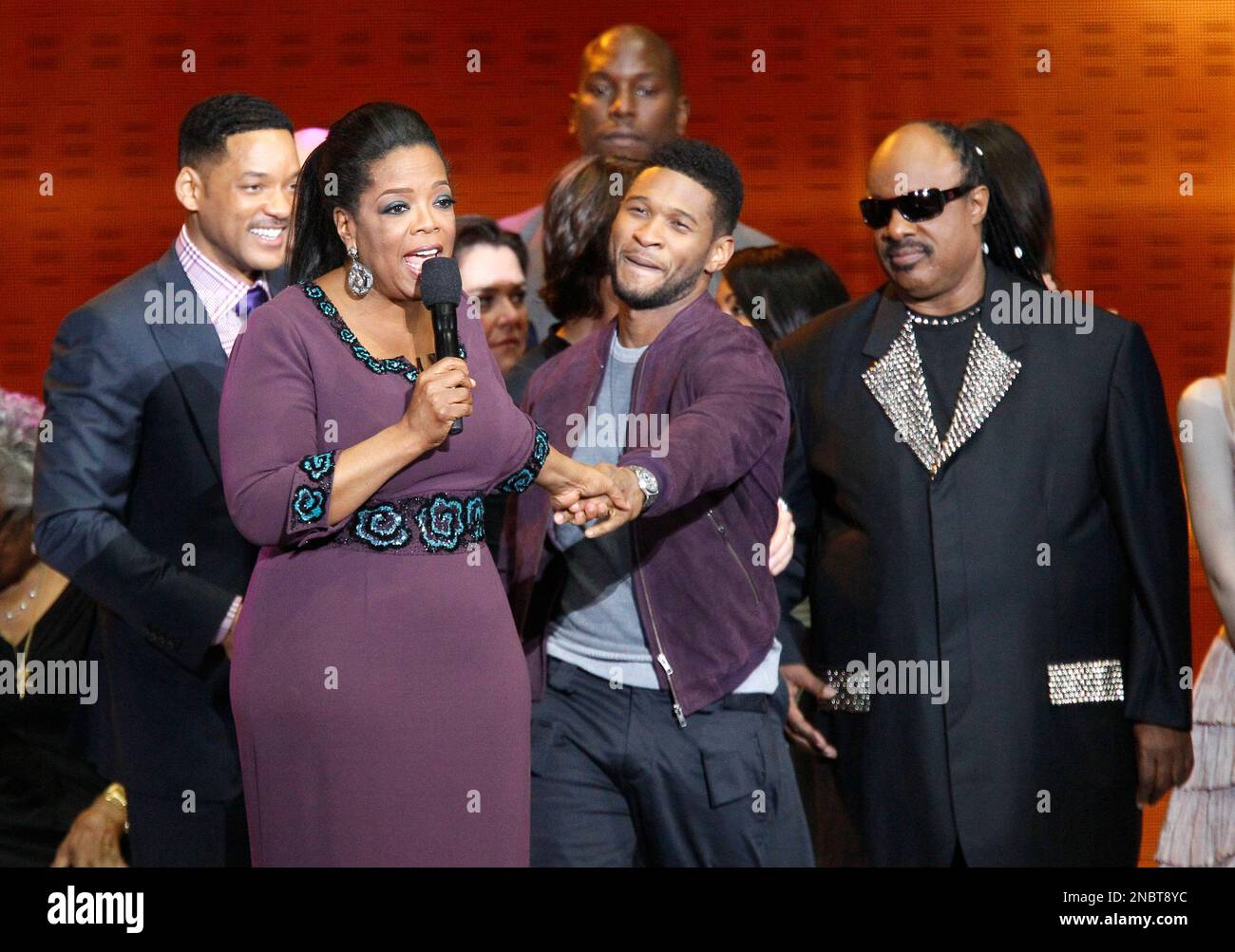 Oprah Winfrey acknowledges fans as she is surrounded by stars during a ...