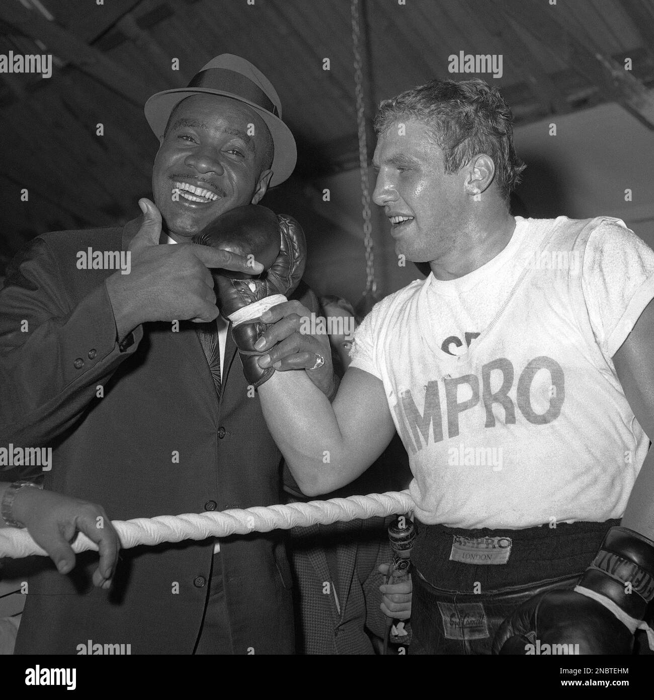 Sonny Liston, the world heavyweight boxing champion, left, jests with ...