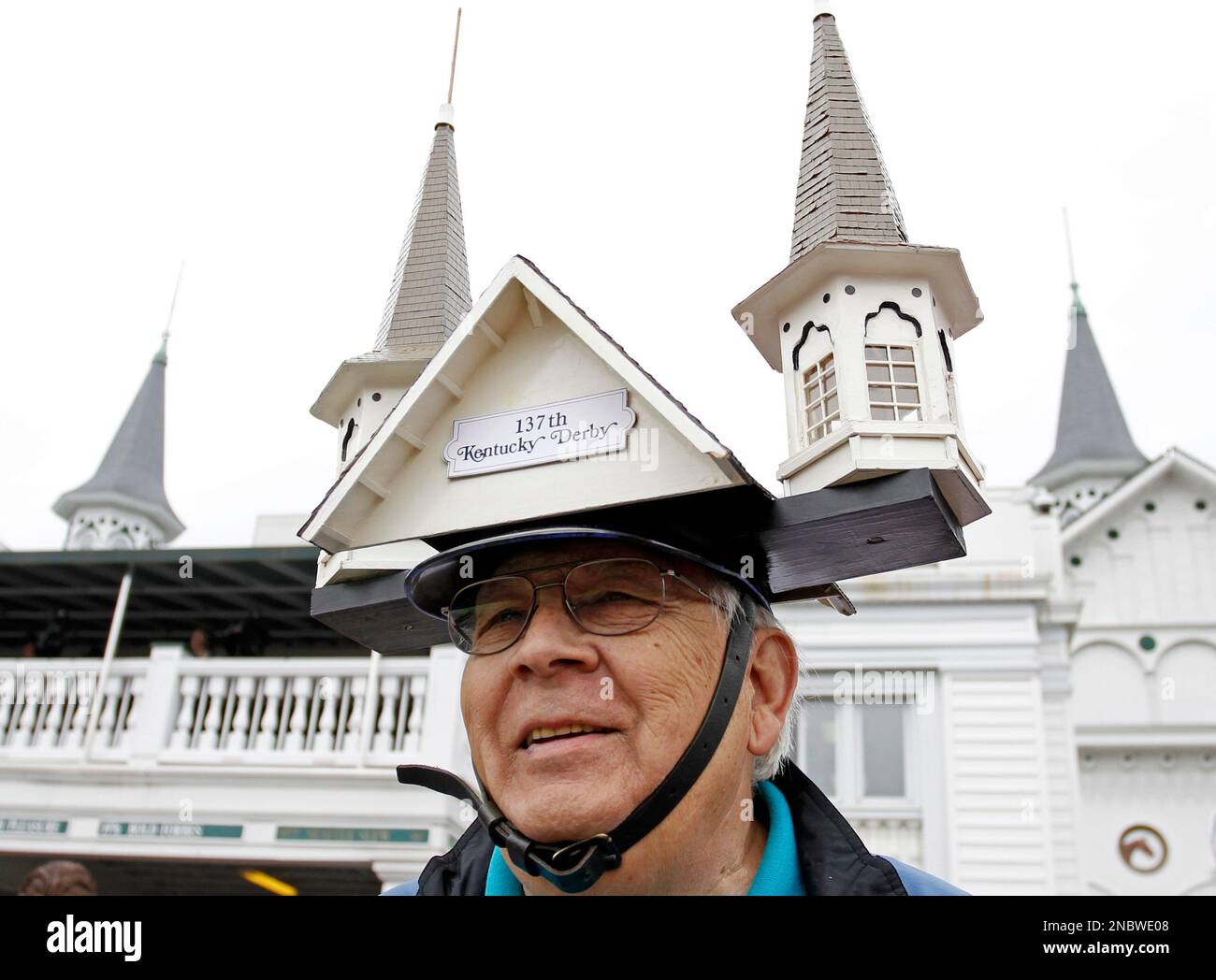 George Holtee, from Prairie Village, Kan, wears a spires hat in the ...