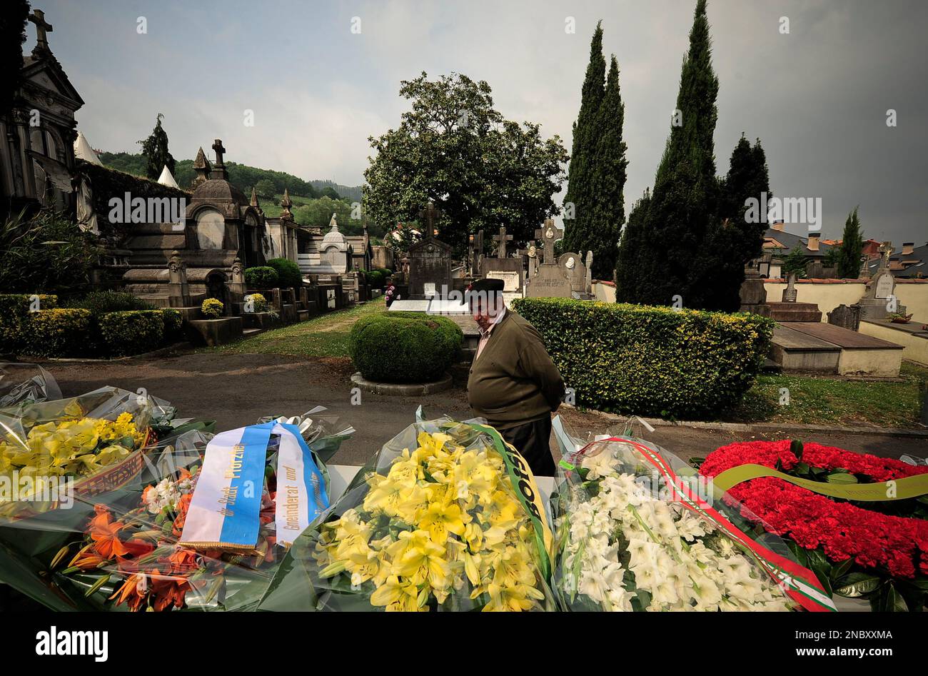 An unidentified Basque survivor looks on bunches of flowers in the ...