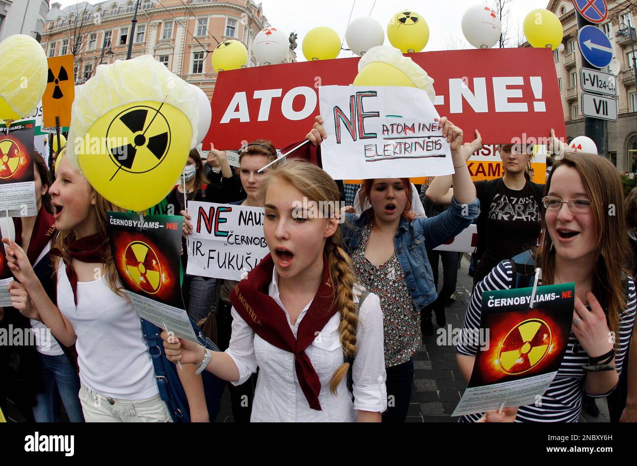 People hold placards during an anti-nuclear protest march in Vilnius ...