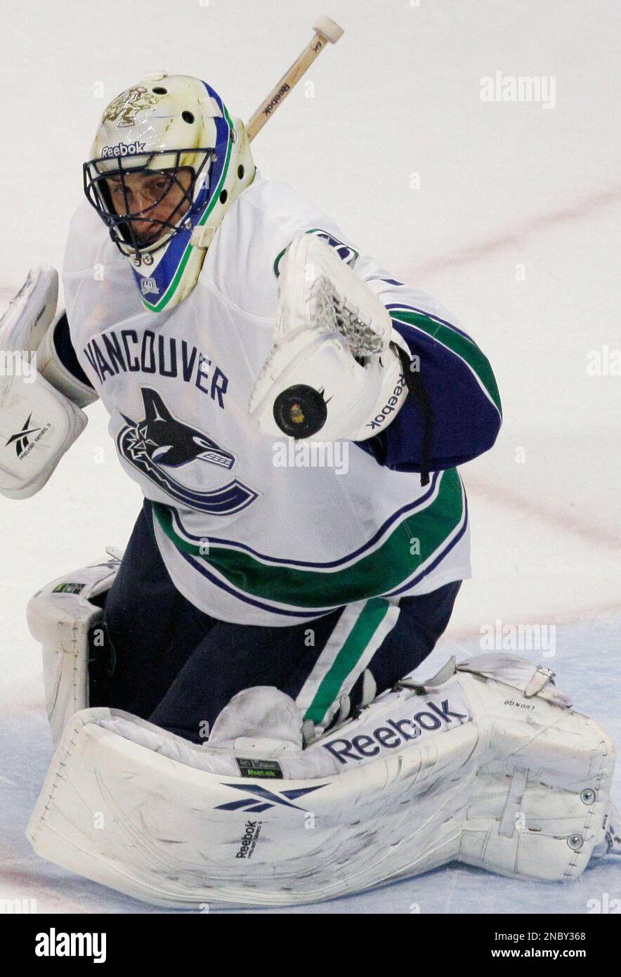Vancouver Canucks goalie Roberto Luongo (1) makes a glove save on a ...