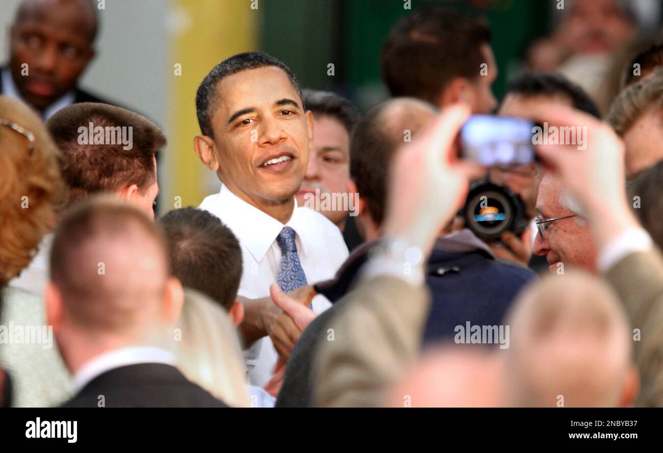 President Barack Obama shakes hands with a member of the audience as he ...