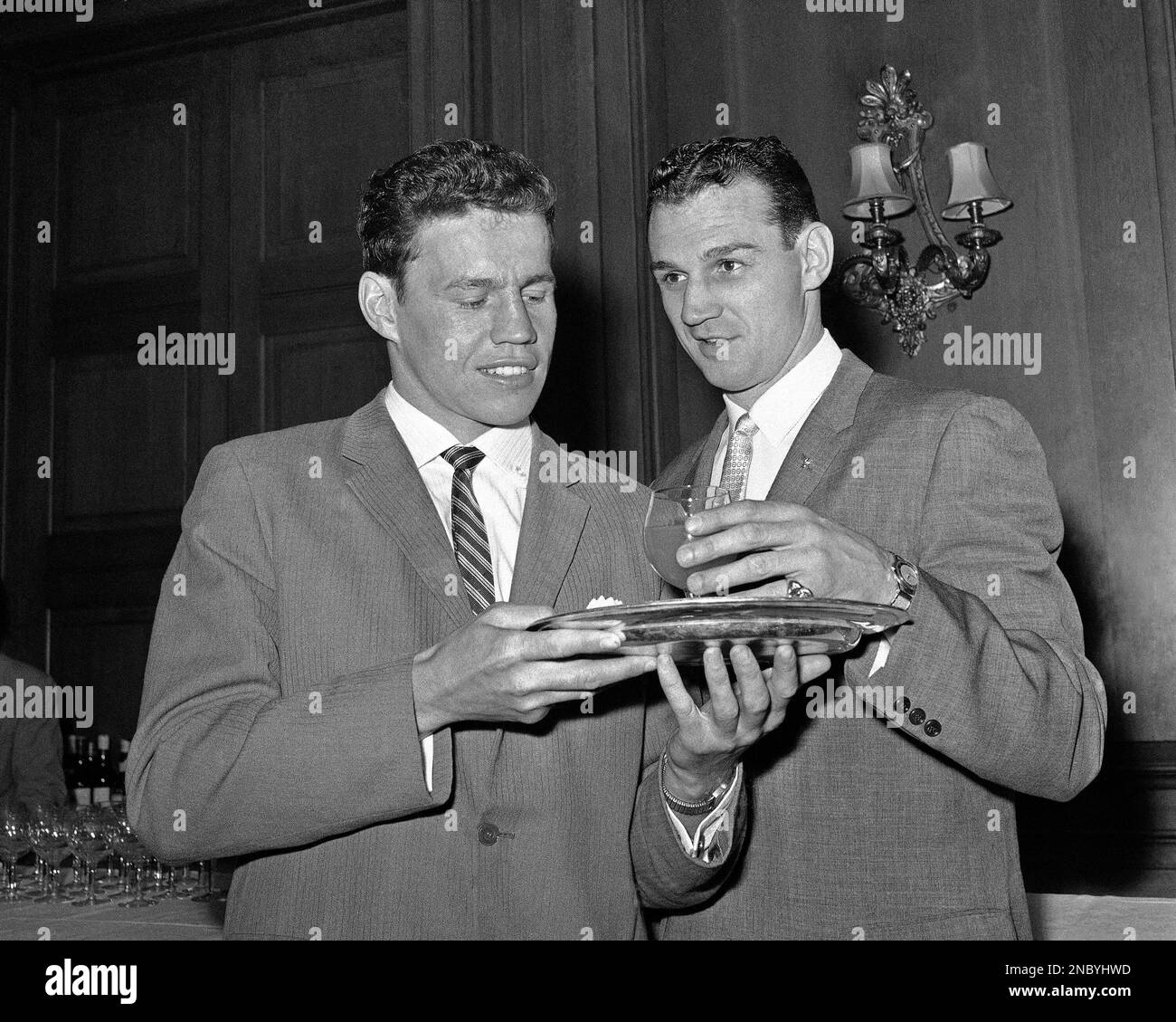 Terry Downes, left, British middleweight champion, offers a soft drink ...