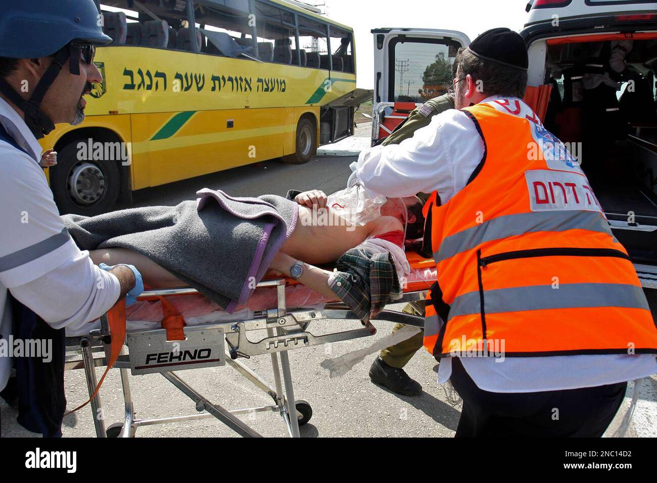 A wounded Israeli is treated by medics at the site where an Israeli ...
