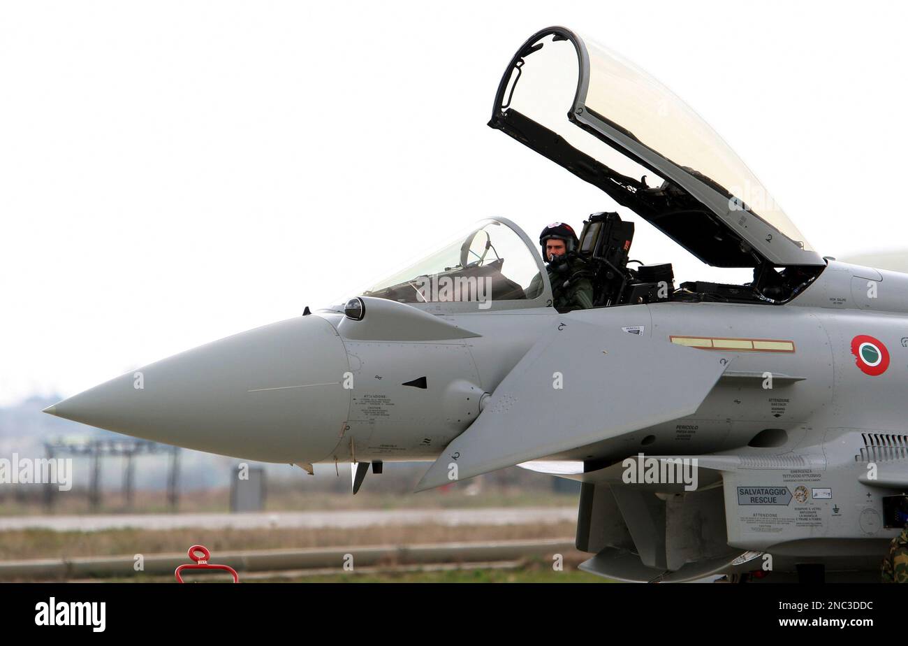 A pilot sits in the cockpit of an Italian air force Eurofighter Typhoon ...