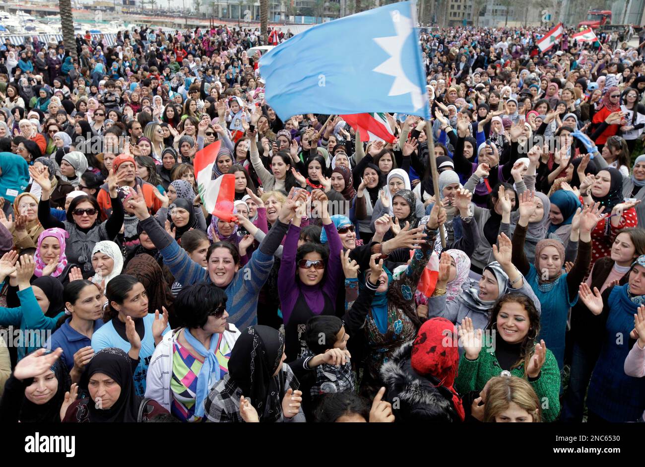 Lebanese women from Hariri's Future Movement wave the party's blue flag ...
