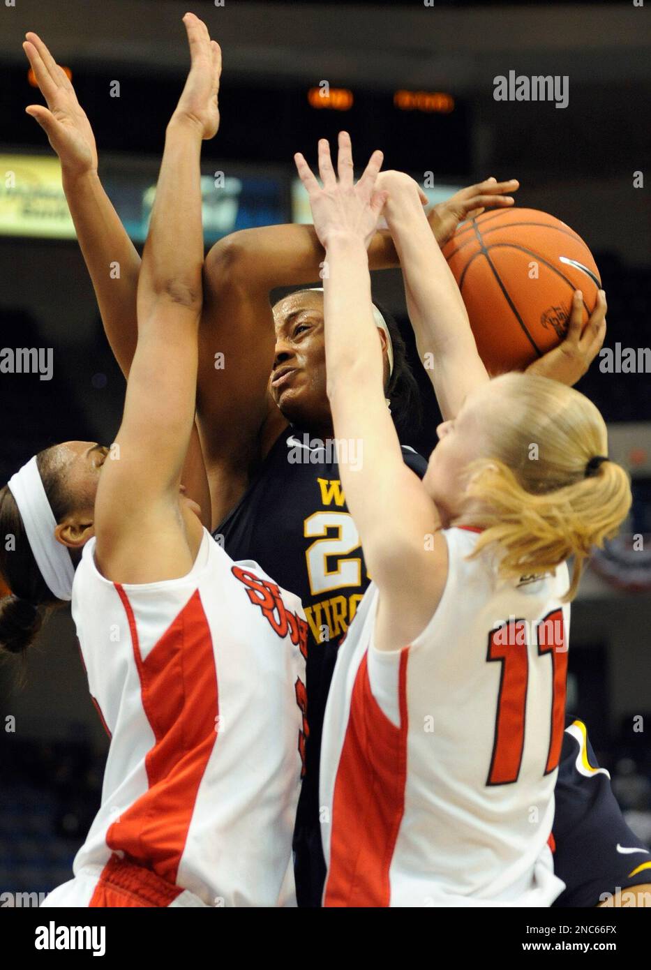 West Virginia's Asya Bussie, center is guarded by St. John's Da'Shena ...