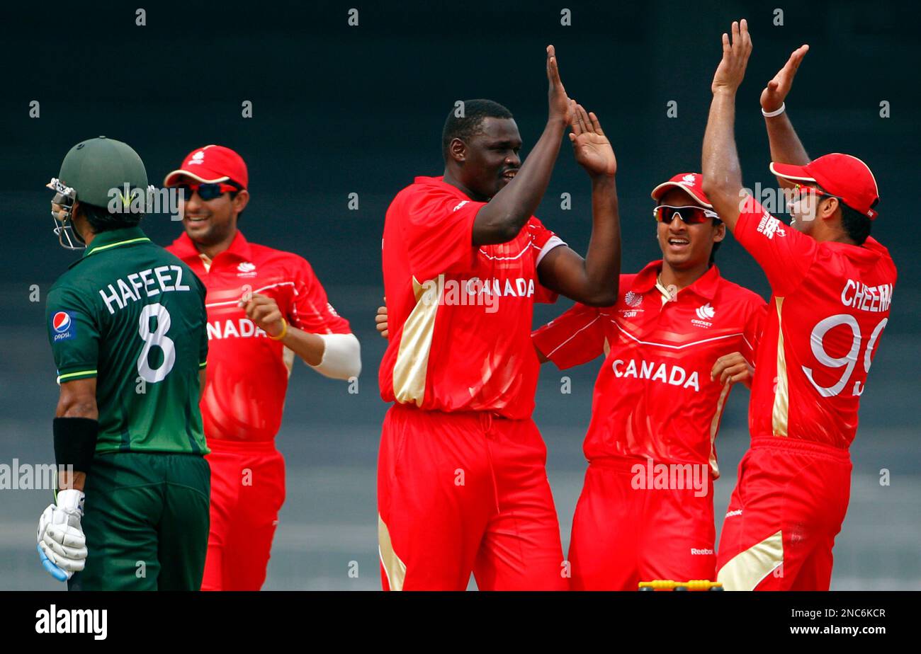 Canada's bowler Henry Osinde, center, celebrates with teammates Rizwan ...