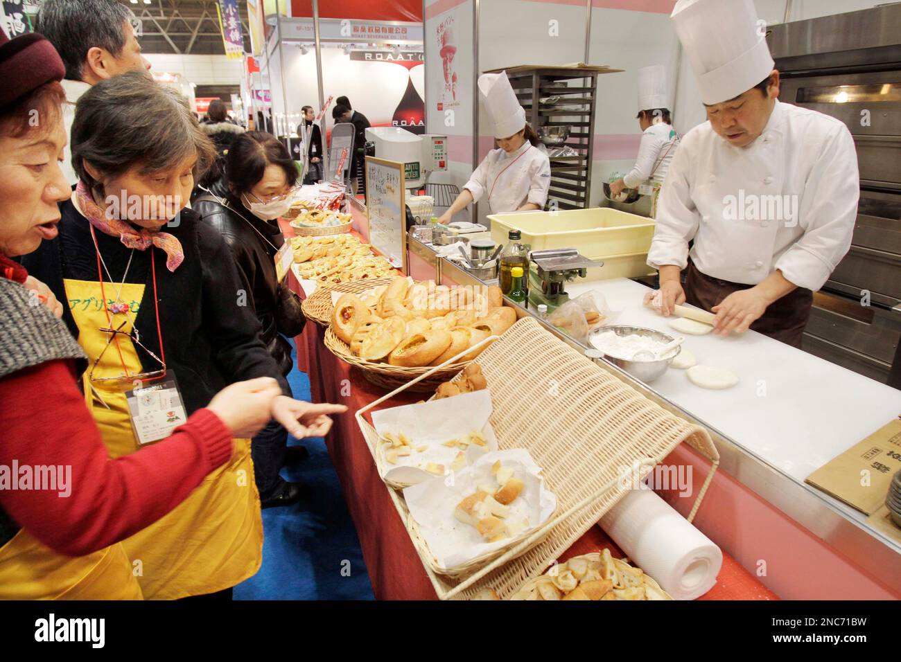 Visitors look at bread baked with 80 percent of rice flour and 20 ...
