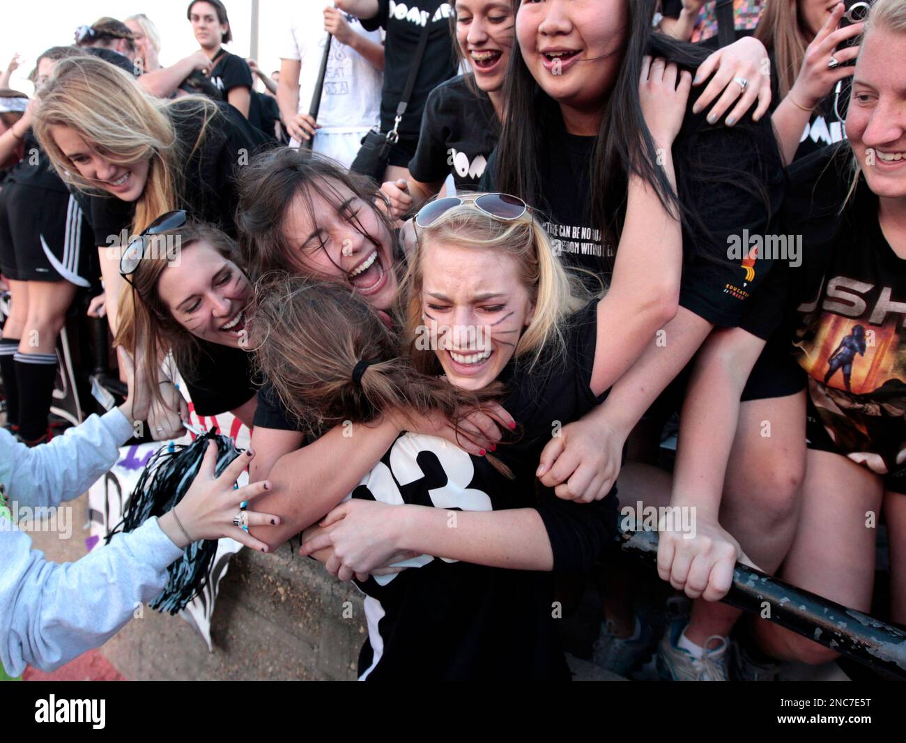 Classmates hug Katherine Cuntz (23), of the Dominican High soccer team ...