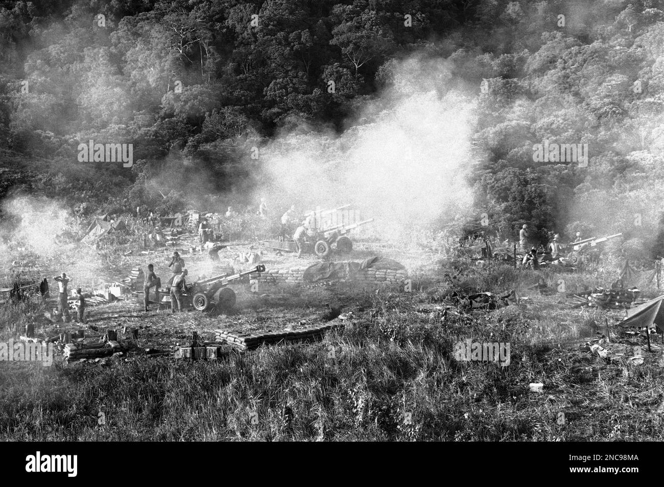 Smoke and haze partially obscure the mountaintop artillery position of ...