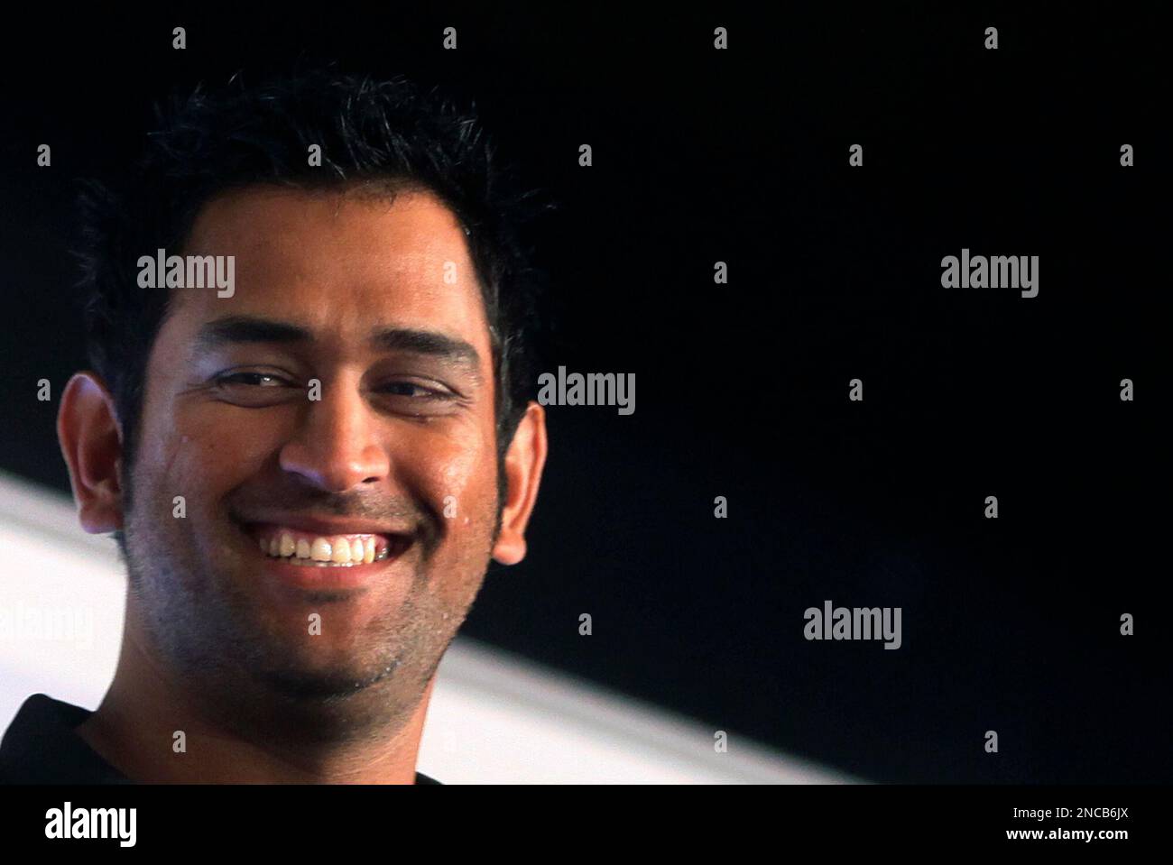 Indian cricket captain Mahendra Singh Dhoni smiles during a promotional ...