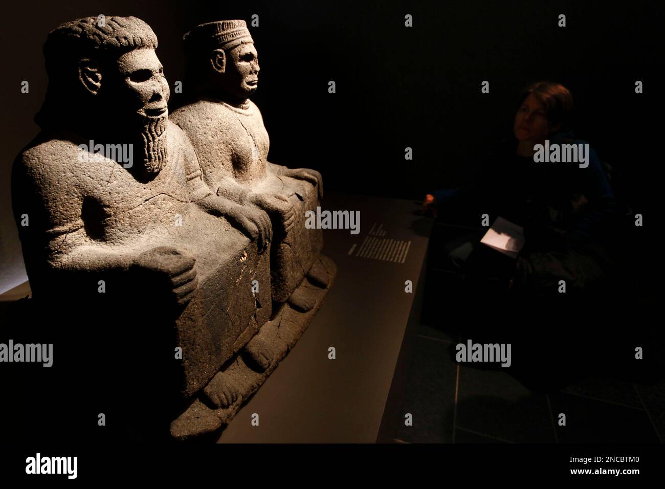 A visitor looks at the reconstructed sculpture of a couple at the ...