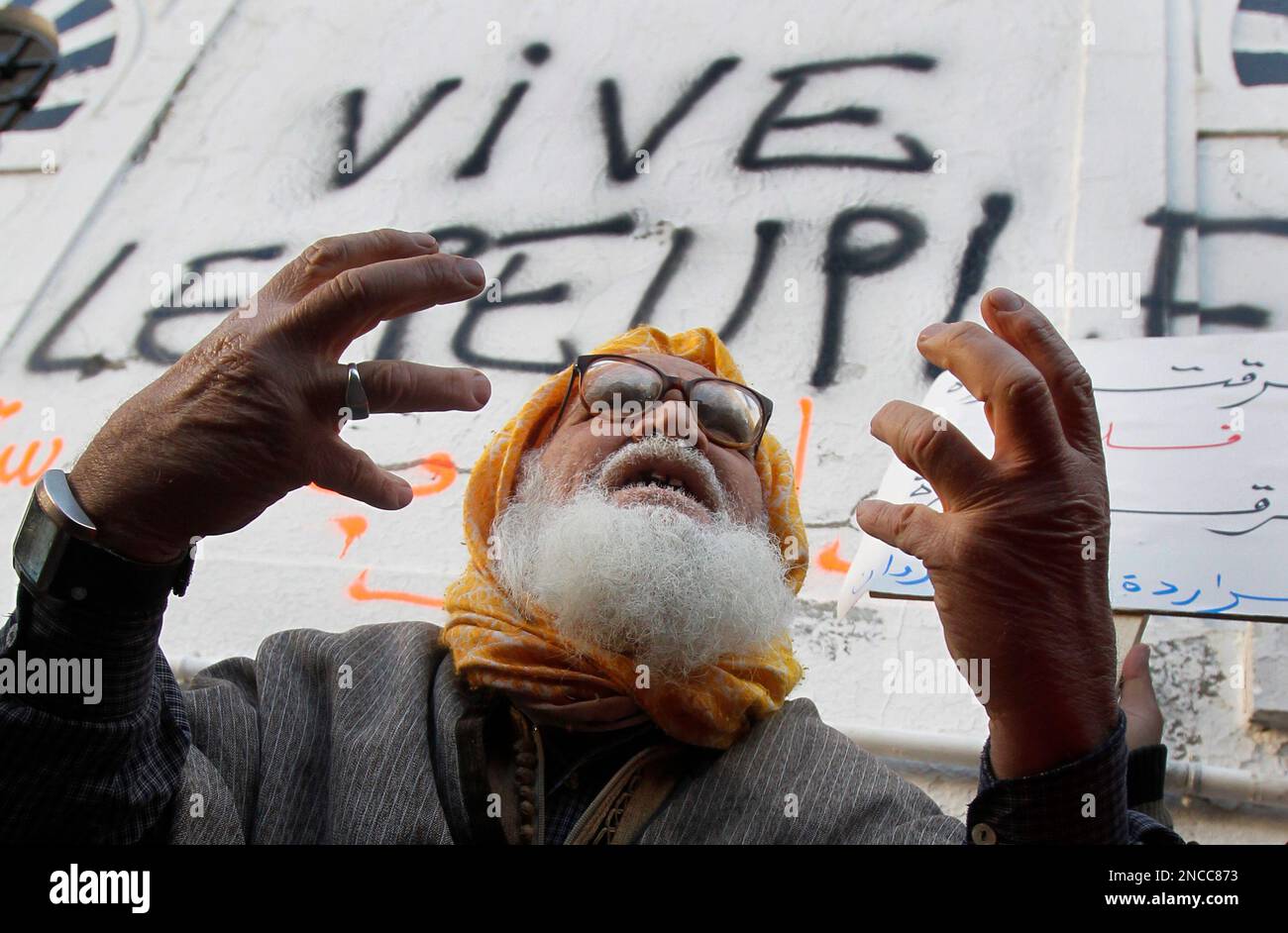 An old man reacts during a demonstration in Tunis, Monday, Jan. 24 ...