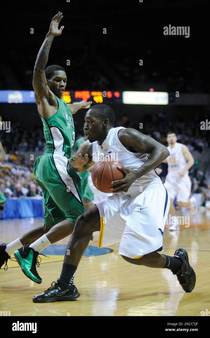 West Virginia's Darryl Bryant, right, looks to drive by Marshall's ...