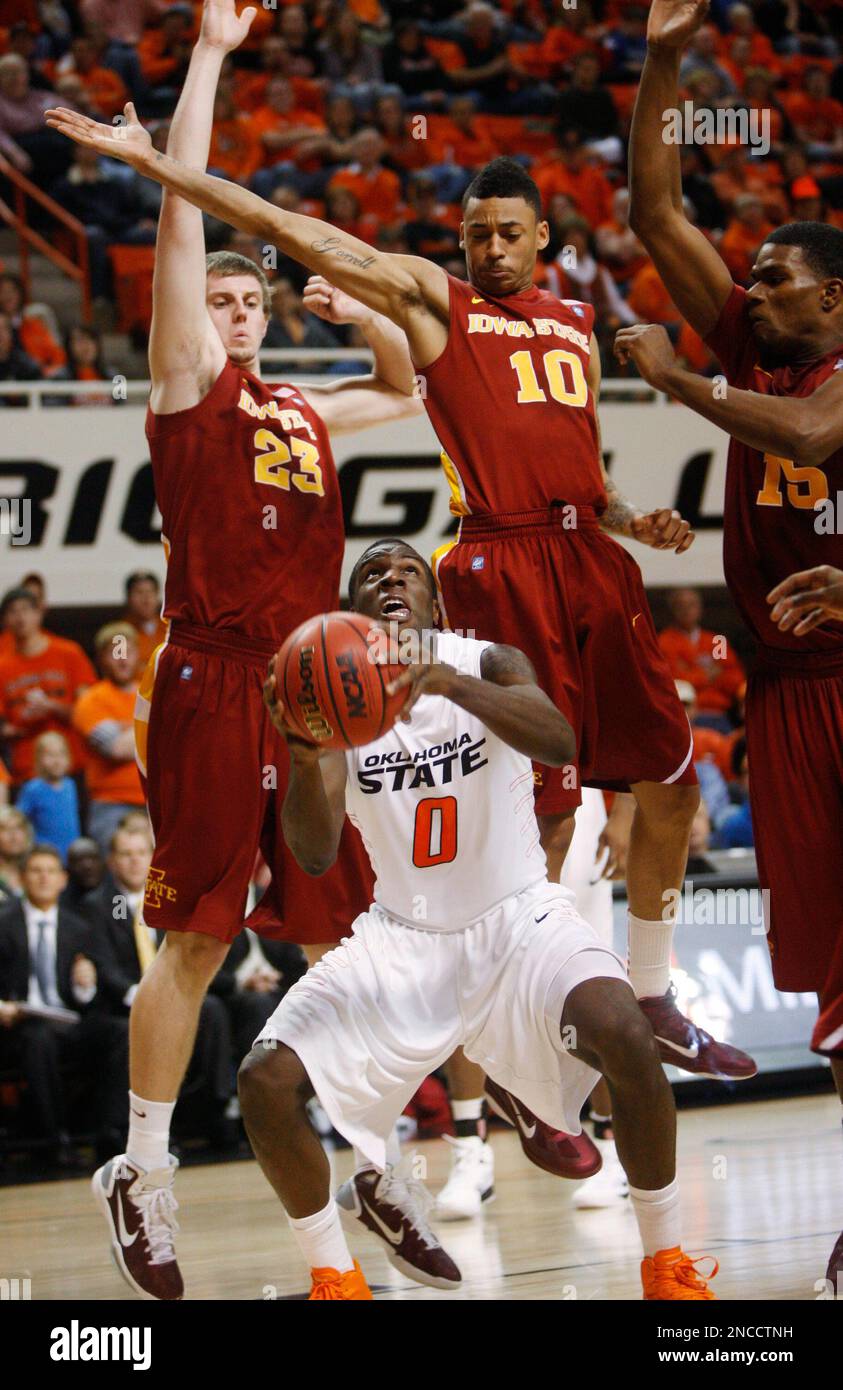 Oklahoma State guard Jean-Paul Olukemi, bottom, looks for a shot as ...