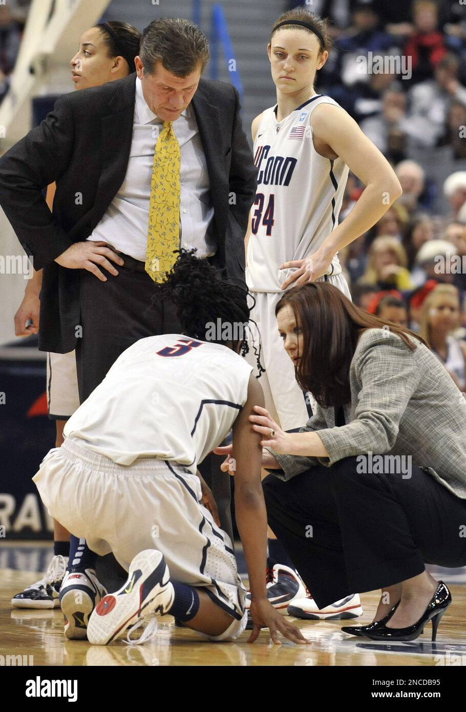 Connecticut's Tiffany Hayes (3) is tended to by trainer Rosemary Ragle ...