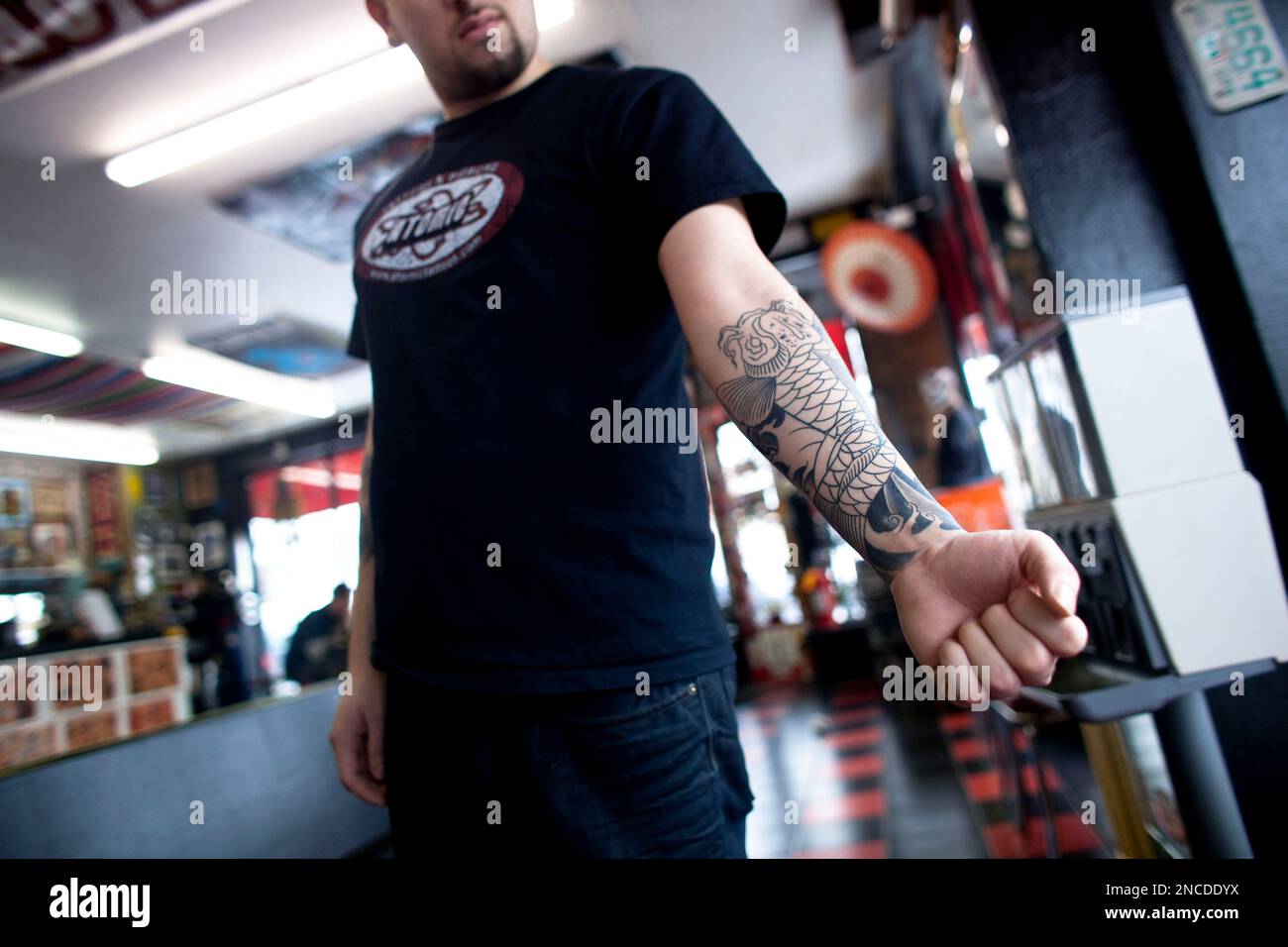 Sammy Limon, an apprentice tattoo artist at Atomic Tattoos, shows off ...