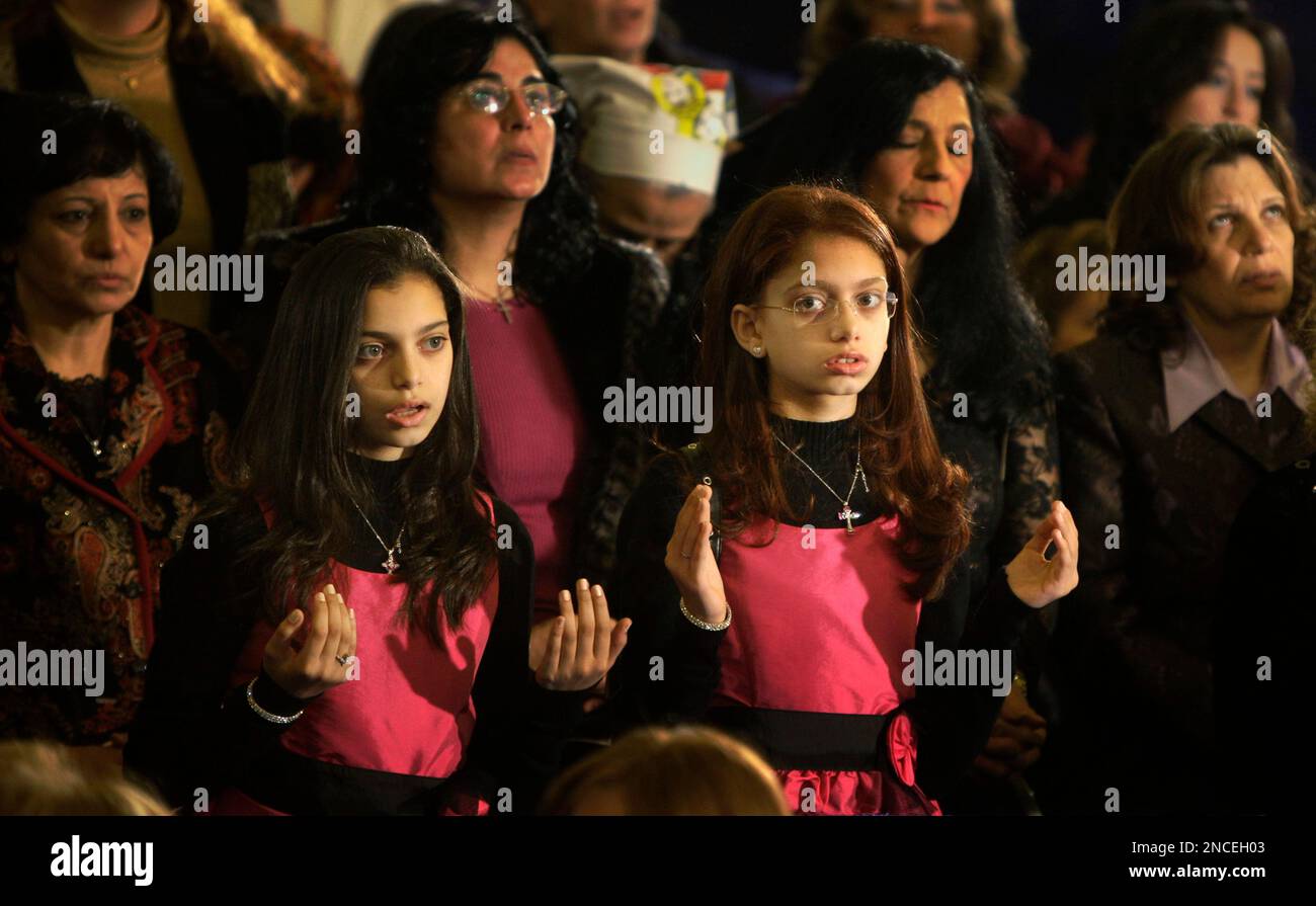 Coptic Christian girls pray during Christmas Eve Mass at the Coptic ...