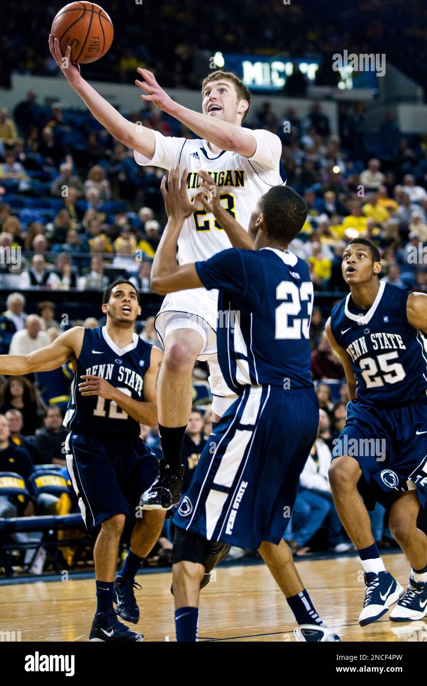 Michigan forward Evan Smotrycz, top, goes to the basket, past Penn ...