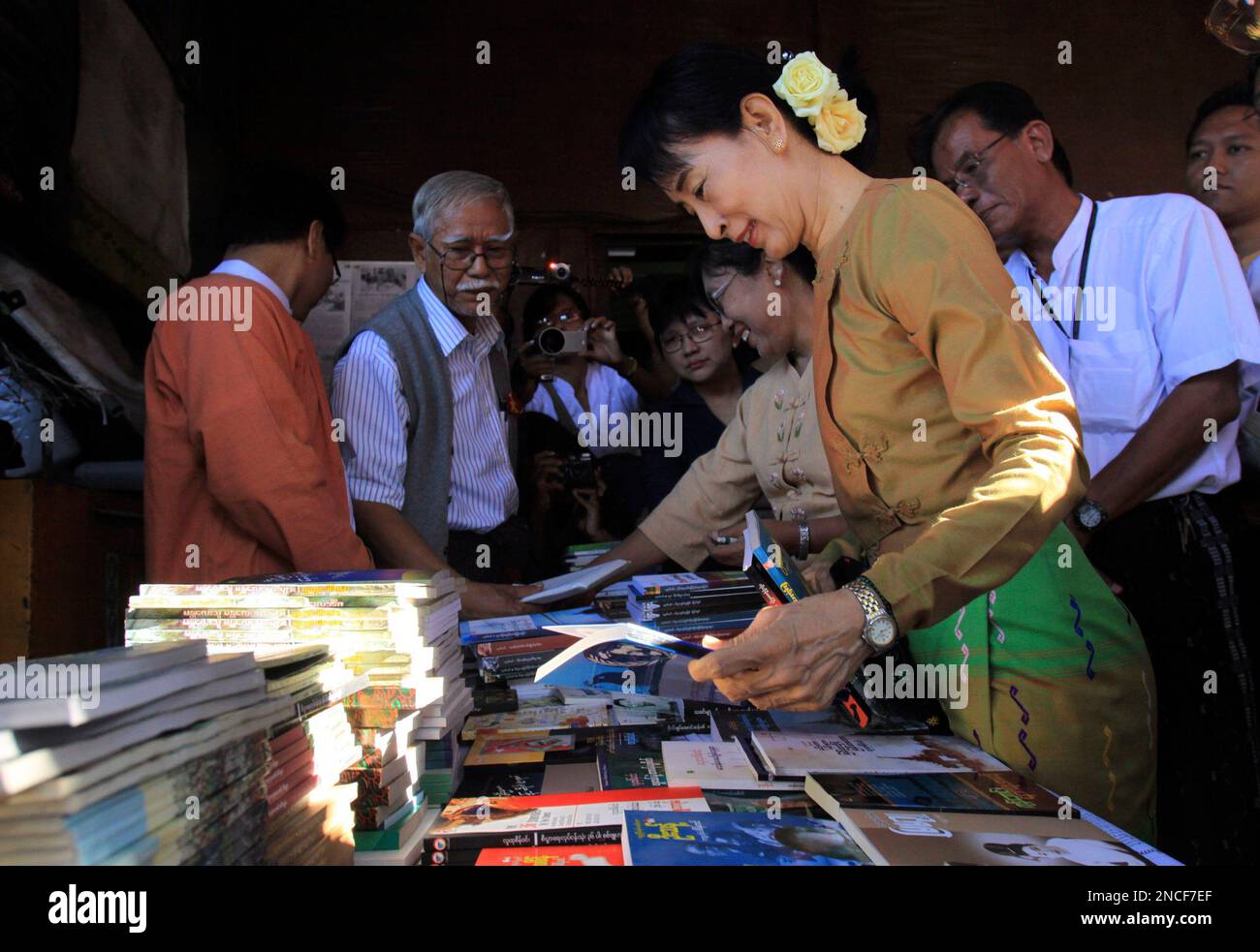 Myanmar pro-democracy leader Aung San Suu Kyi, right, looks at books ...