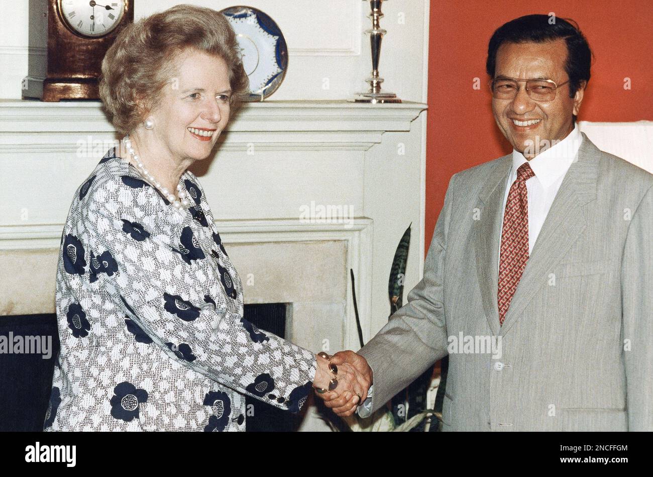 The Malaysian Premier, Datuk Seri Dr. Mahathir Mohamad, shakes hands with British Prime Minister ...