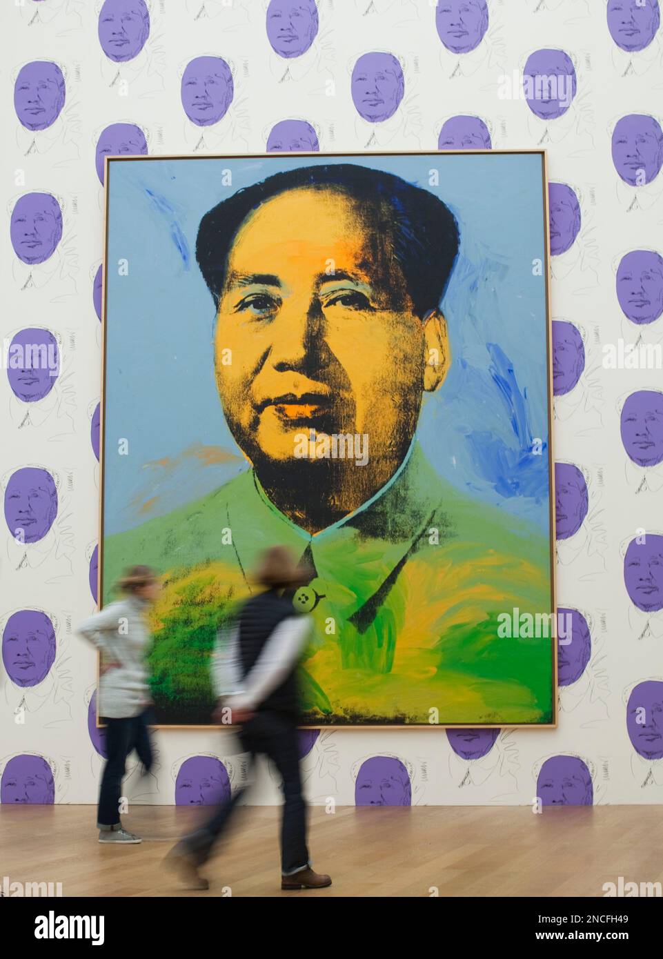 Visitors take a look at the famous portrait of Chinese Communist leader ...