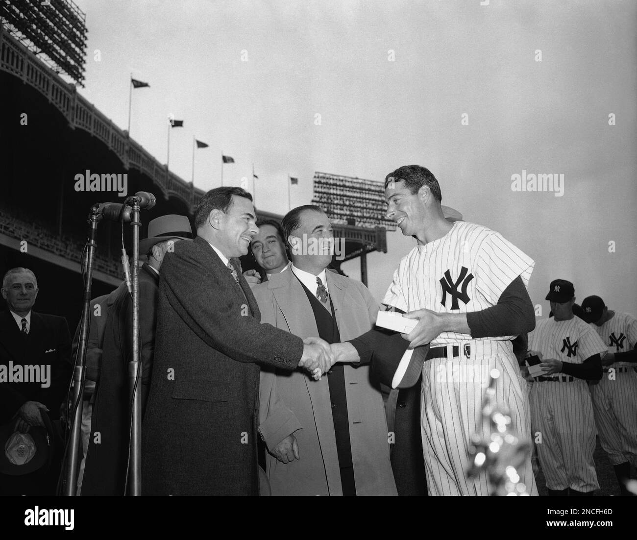Joe DiMaggio, right, New York Yankee outfielder, is congratulated by ...