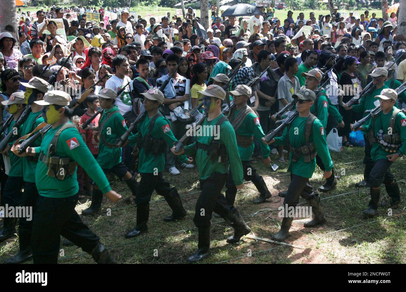 Communist New People Army march in unison in front of local residents ...