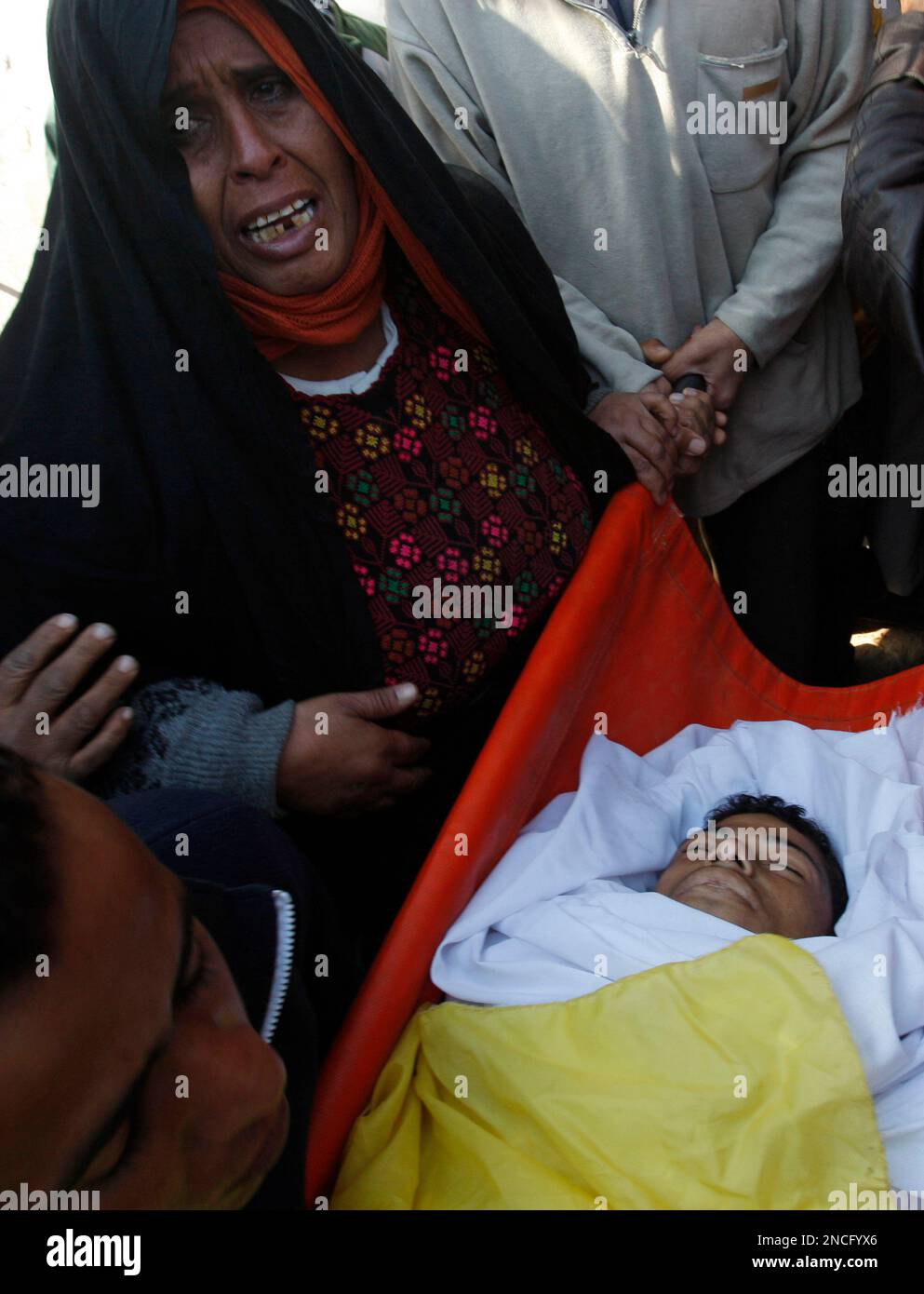 A Palestinian woman mourns over the body of Salama Abu Hashish, 22 ...