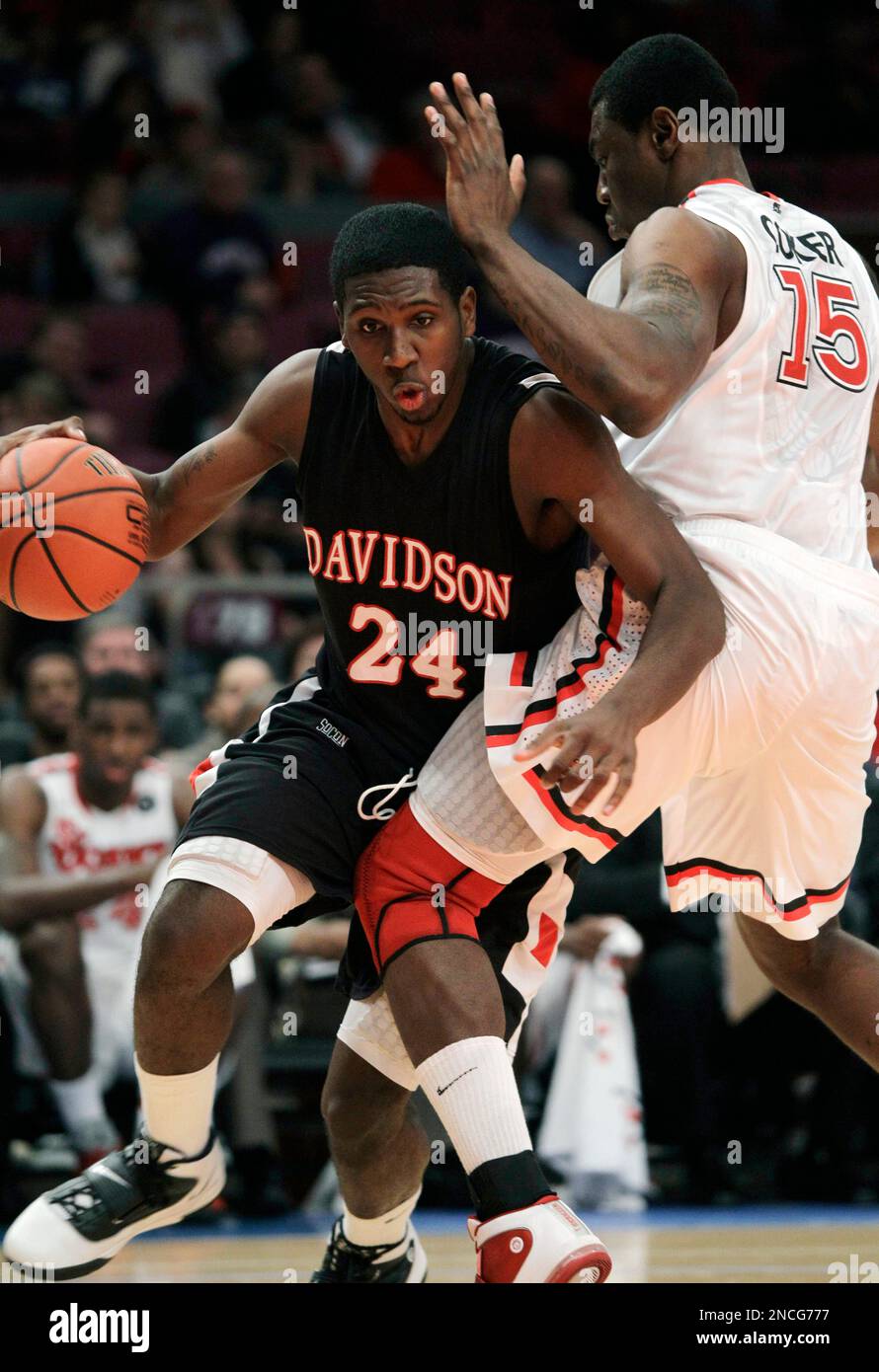 Davidson forward De'Mon Brooks (24) drives past St. John's Dele Coker ...