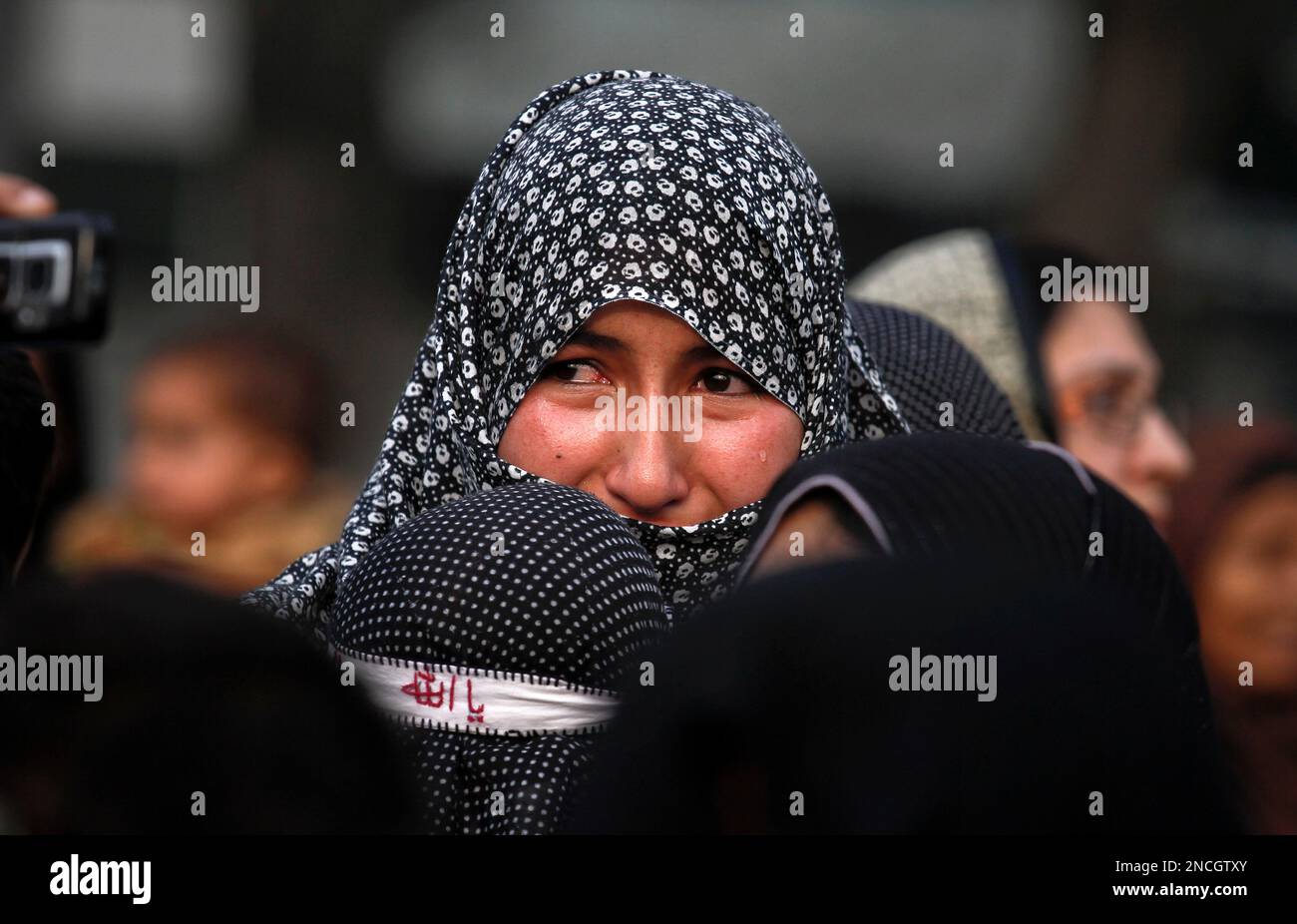 A Pakistani Shiite Muslim woman mourns the death of Shiites' spiritual ...