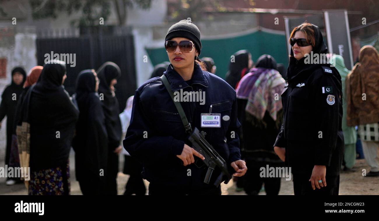A Pakistani female police officer watches the crowds during the ...