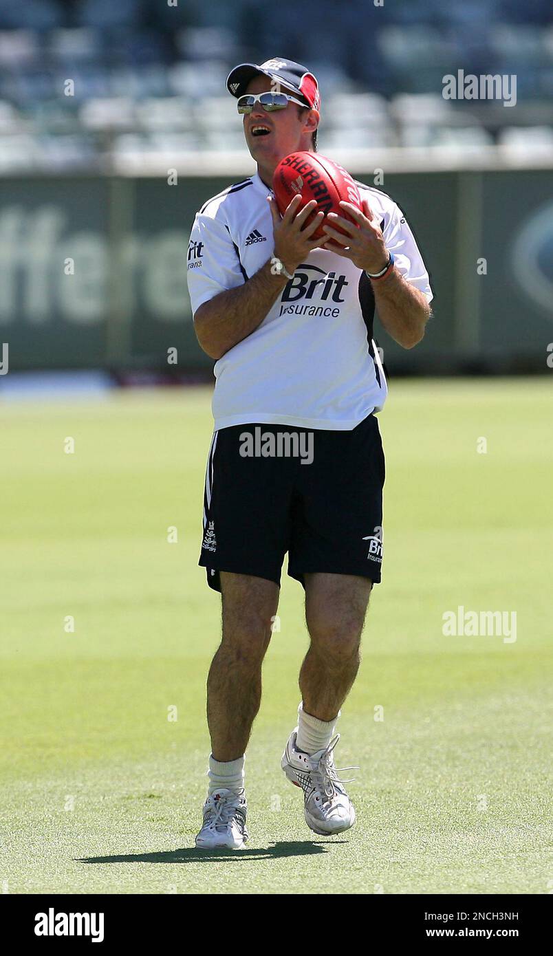 England's cricket captain Andrew Strauss plays with an Australian rules ...